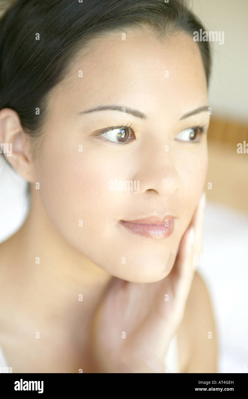 Woman Holding Hand to Face Stock Photo - Alamy