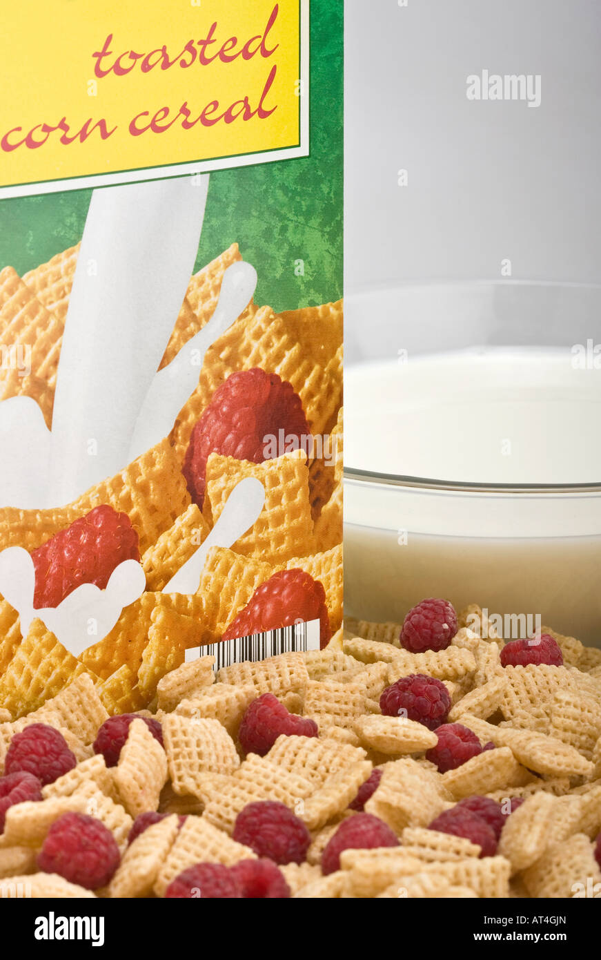 Cereal box Corn Squares and Raspberries with a glass bowl of milk ...