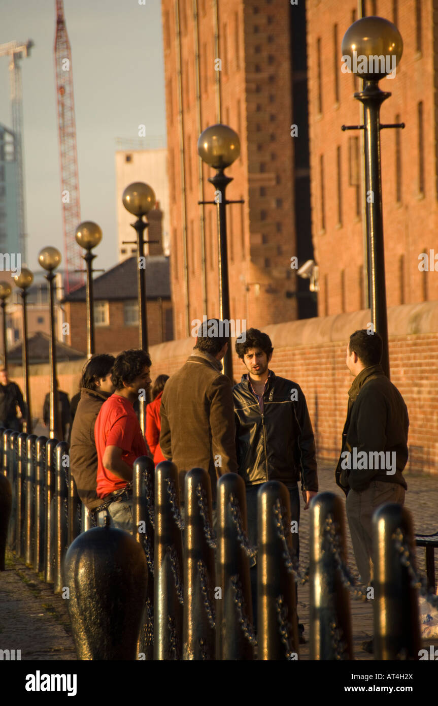 group of young british asian men talking at Albert Dock Liverpool at ...