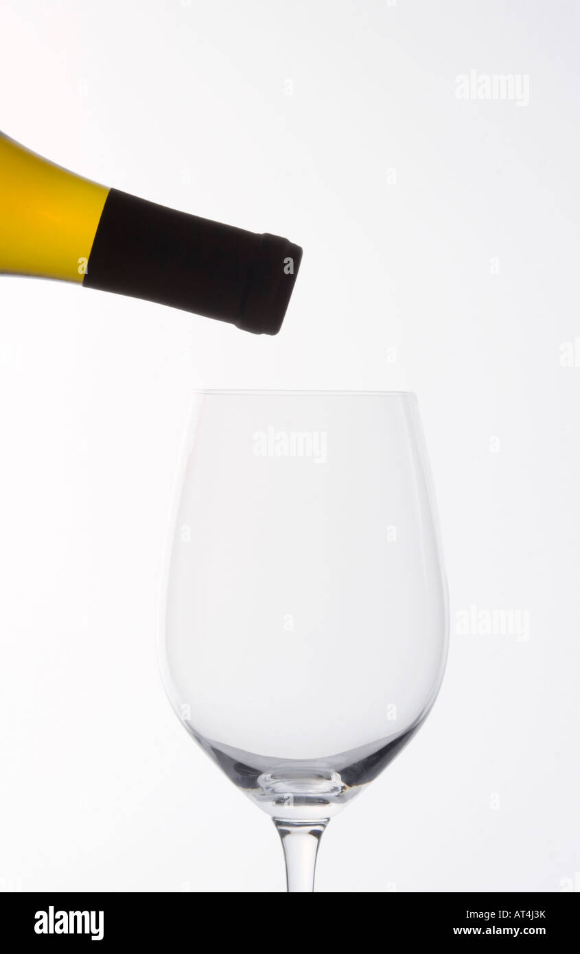 Concept shot with a wine glass and a sealed bottle of white wine Stock ...