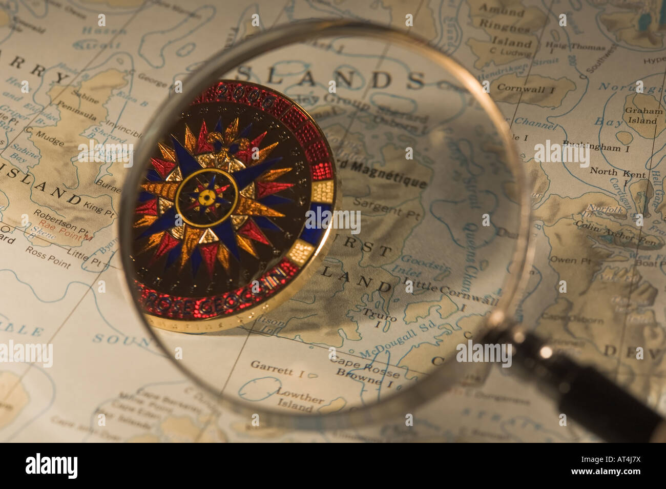 Map and compass reading with a magnifying glass Stock Photo - Alamy