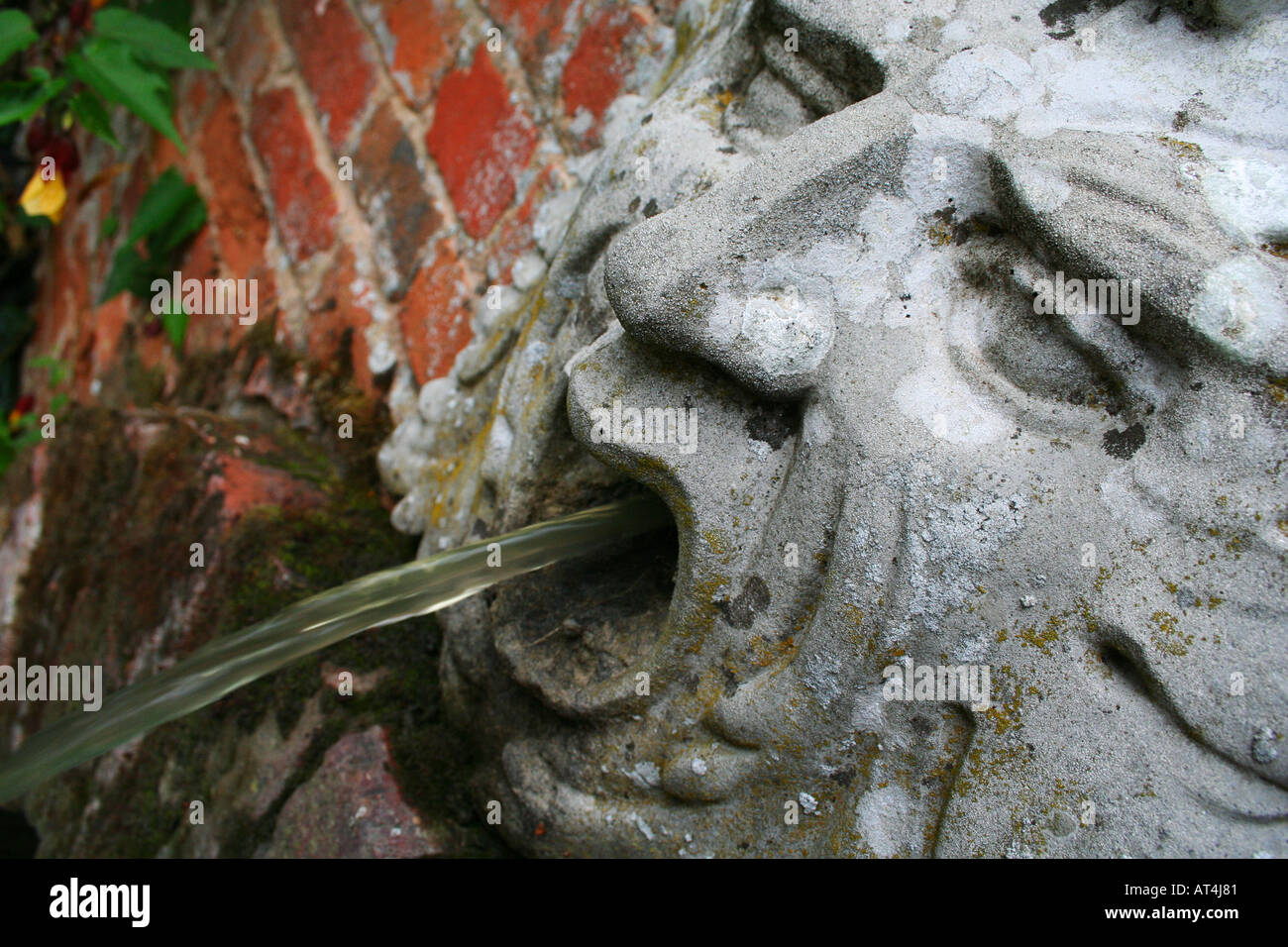 Stone head water feature Stock Photo - Alamy