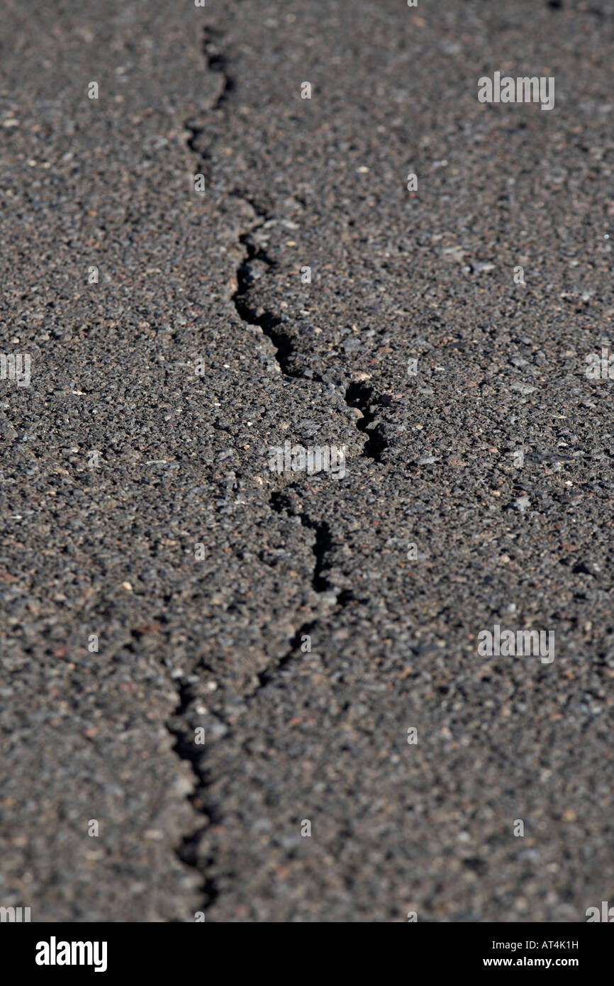 crack in the road caused by expansion contraction and subsidence ...