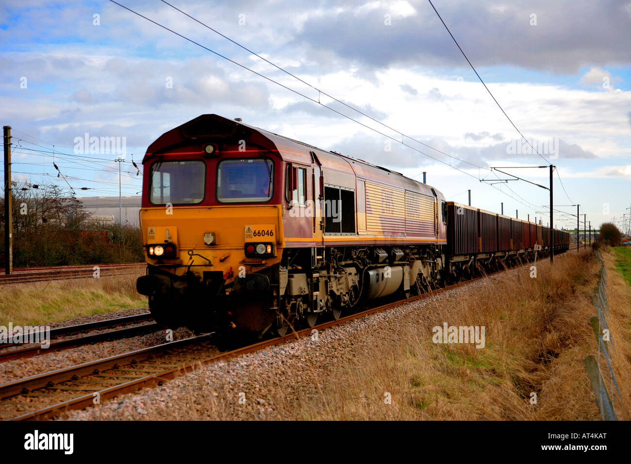 EWS 66046 Diesel with a line of hoppers heading north at Werrington ...