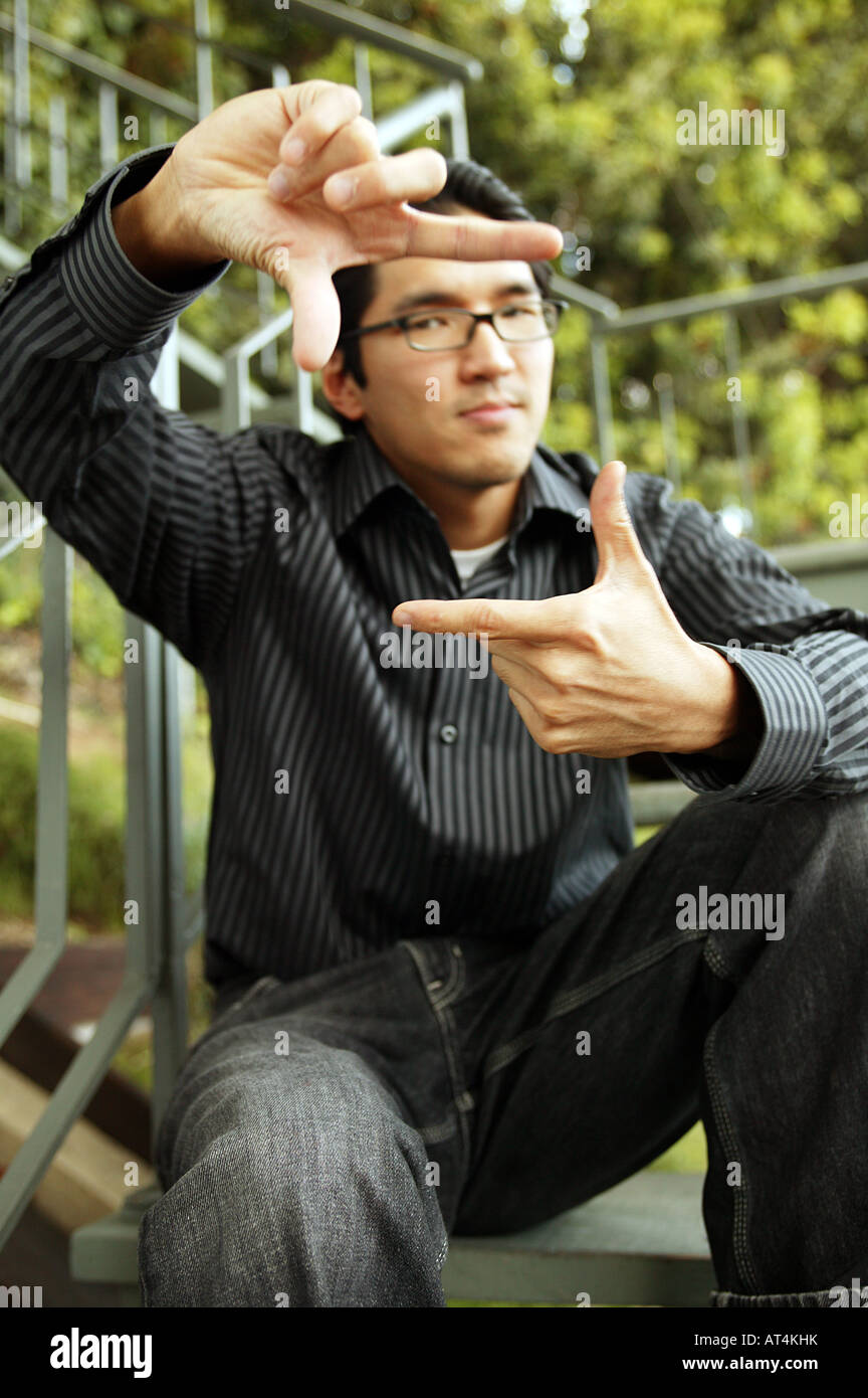 Man Framing Face with Fingers Stock Photo - Alamy