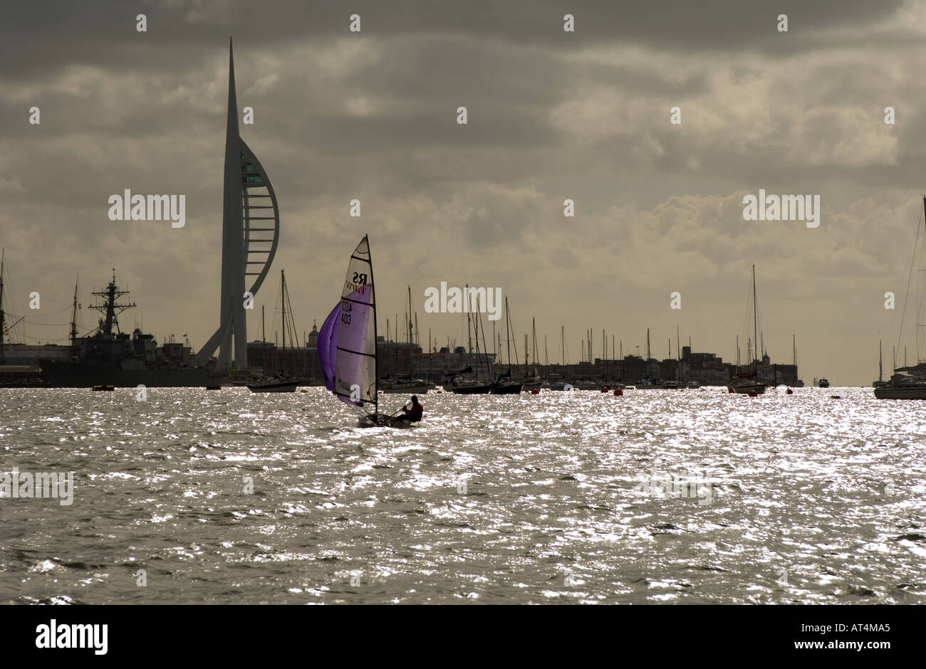 A dinghy sails under it's spinnaker, in contrast with the Spinnaker ...