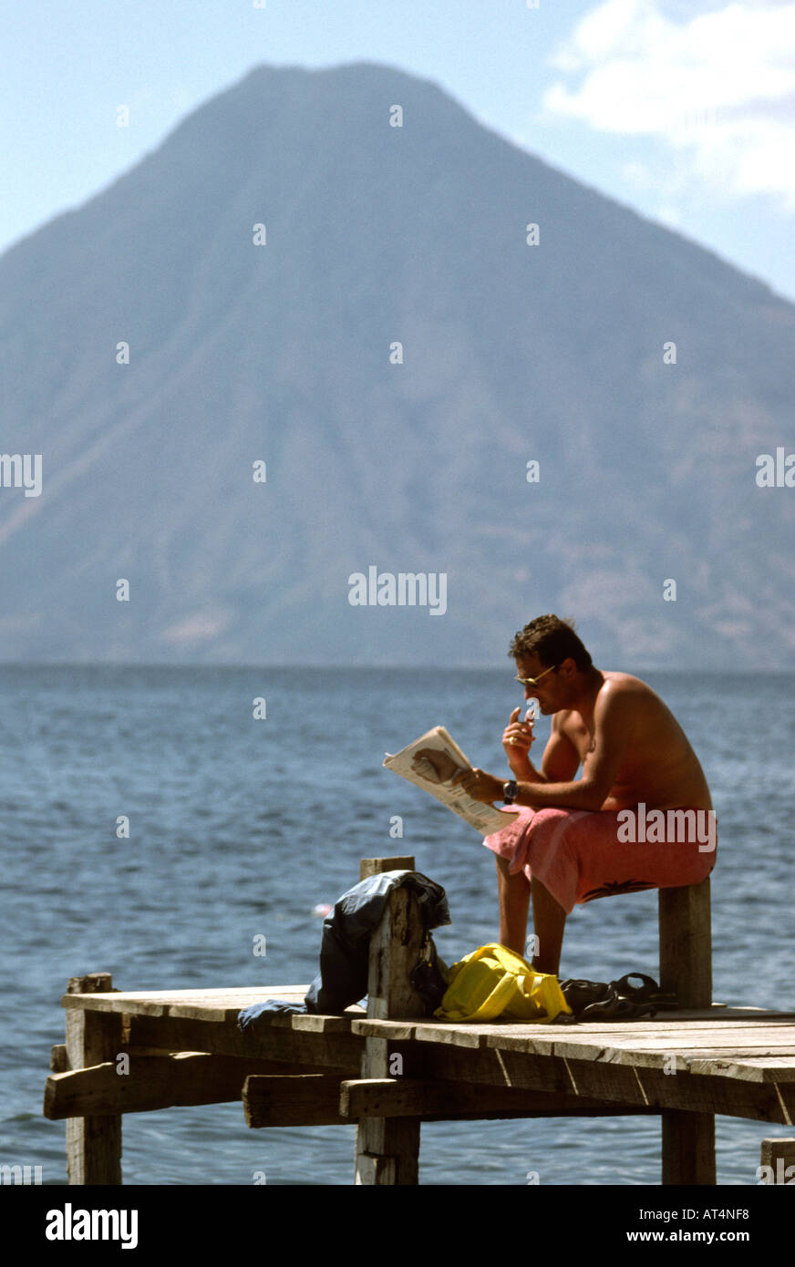 Guatemala Lake Atitlan man reading on pier Stock Photo - Alamy