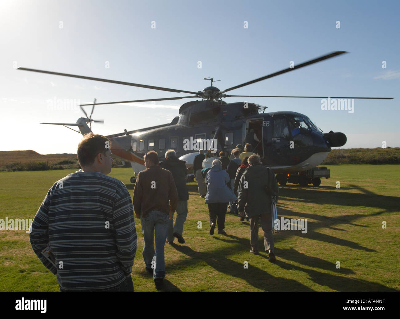 Passengers boarding British International passenger helicopter, Tresco ...