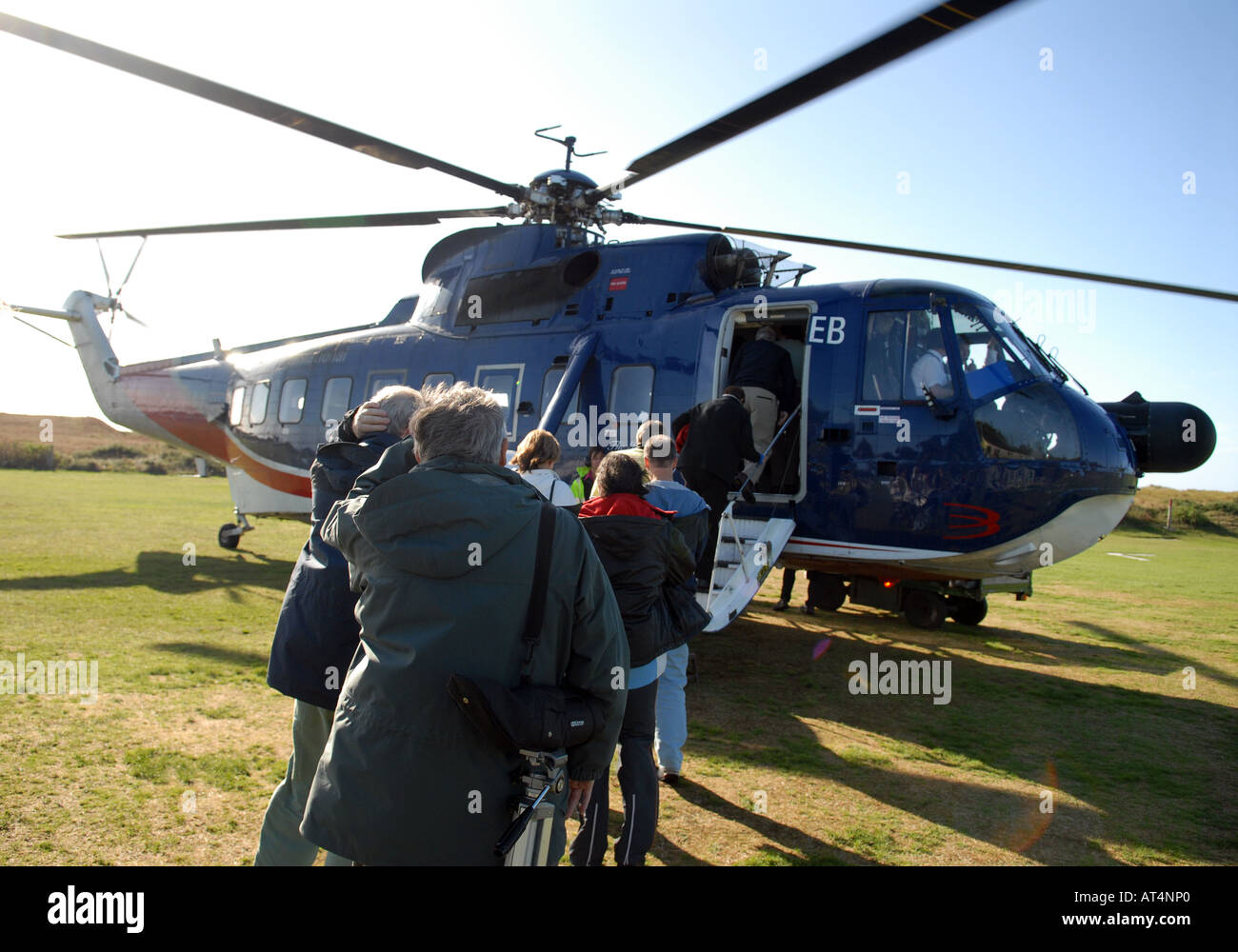 Passengers boarding British International passenger helicopter, Tresco ...