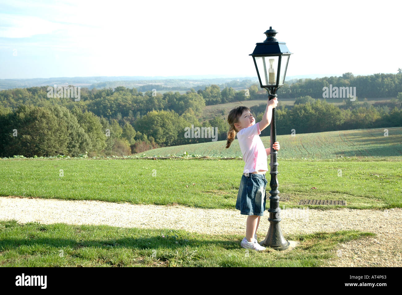 Girl by a lamp post Stock Photo - Alamy