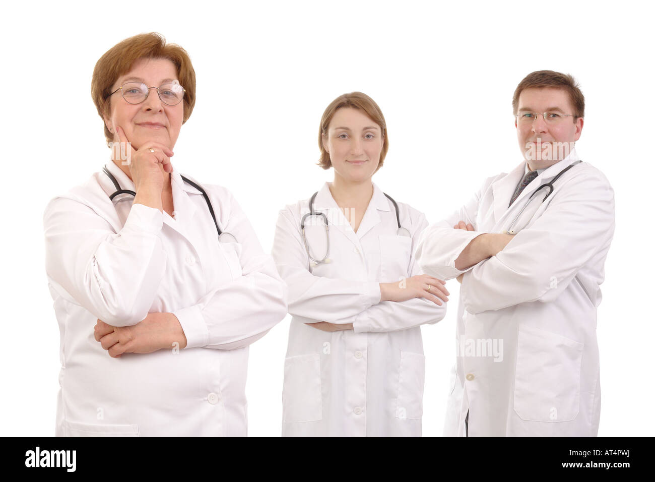 Senior female doctor and two young interns posing over white background ... Senior female doctor and two young interns posing over white background ...
