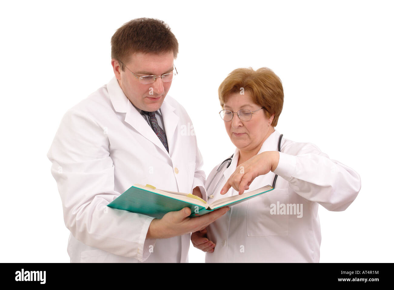 Young male and senior female doctors discussing medical case in the ...