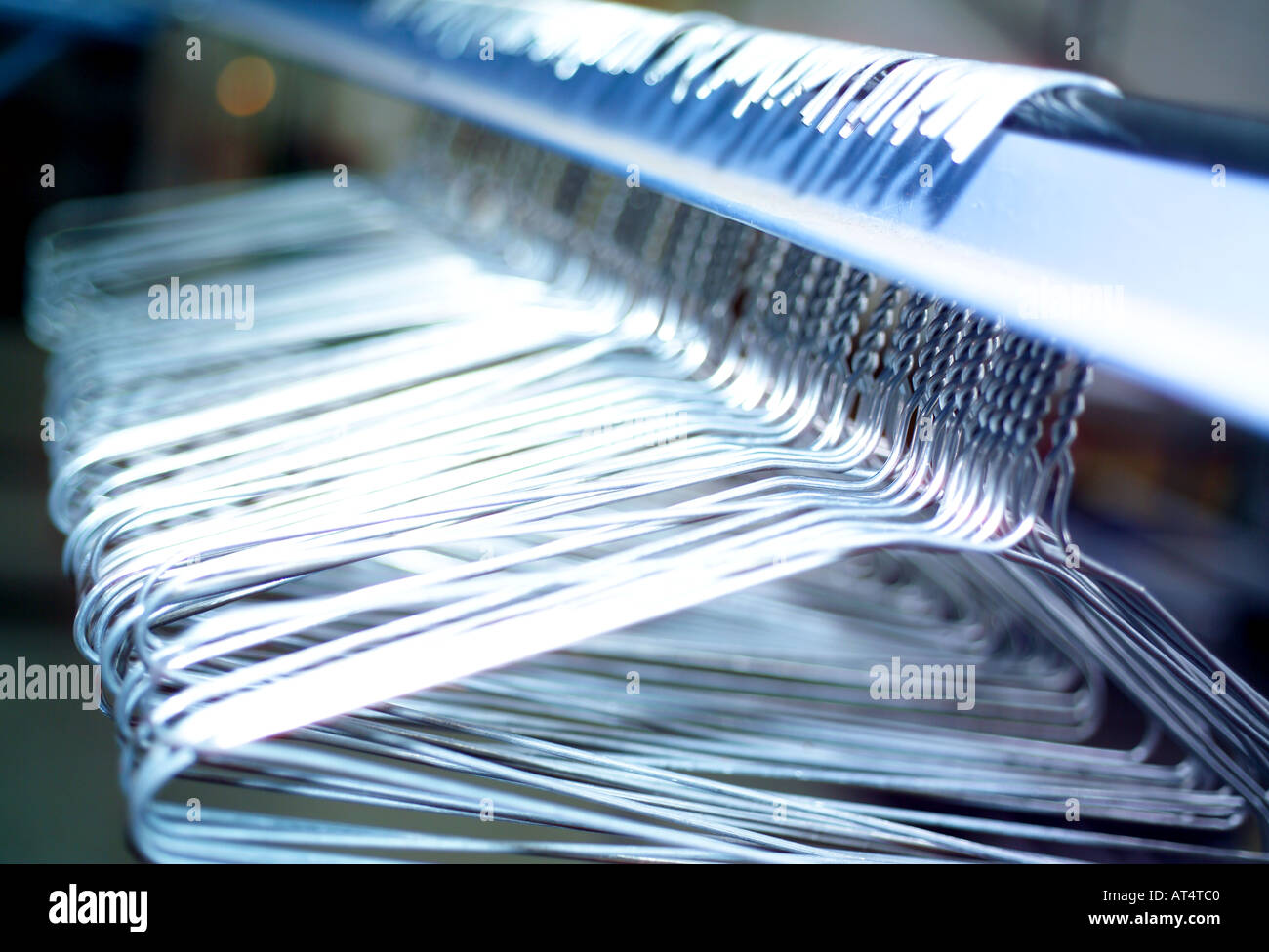 Metal coat hangers in a row Stock Photo - Alamy