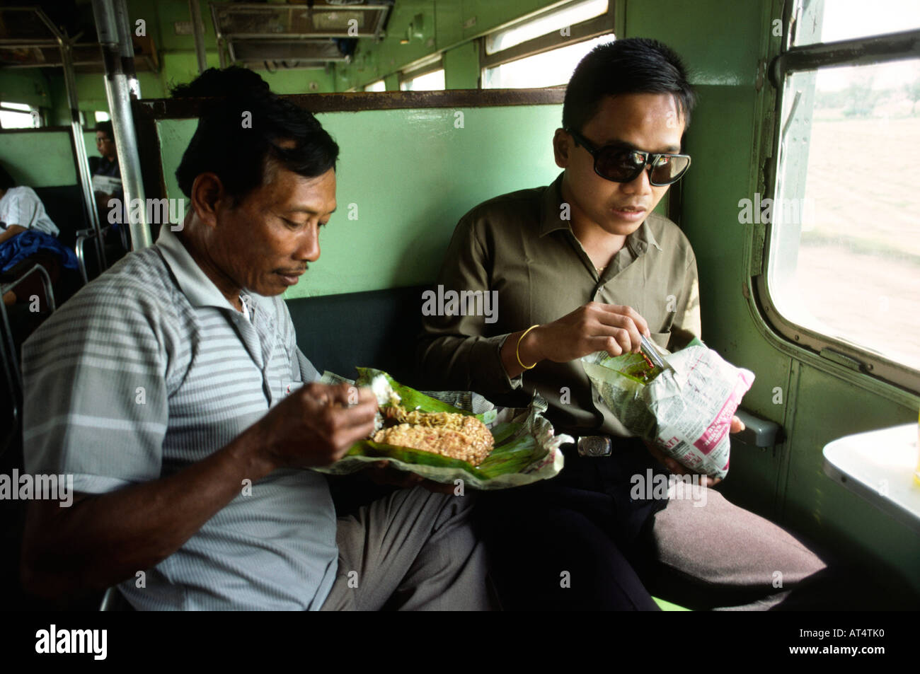 Indonesia Java food men eating snacks on train Stock Photo - Alamy