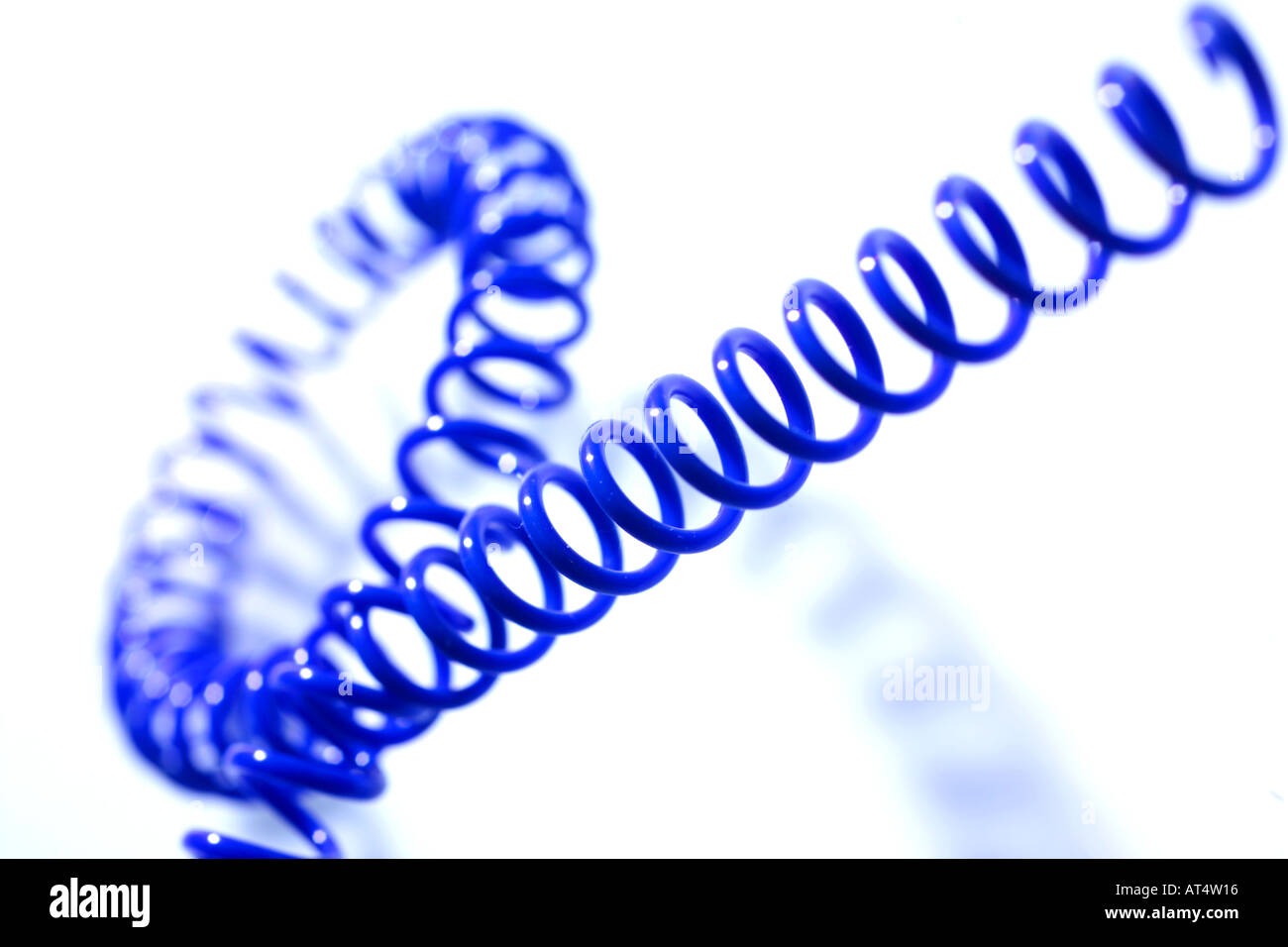 Blue Plastic Spring against white background Stock Photo - Alamy