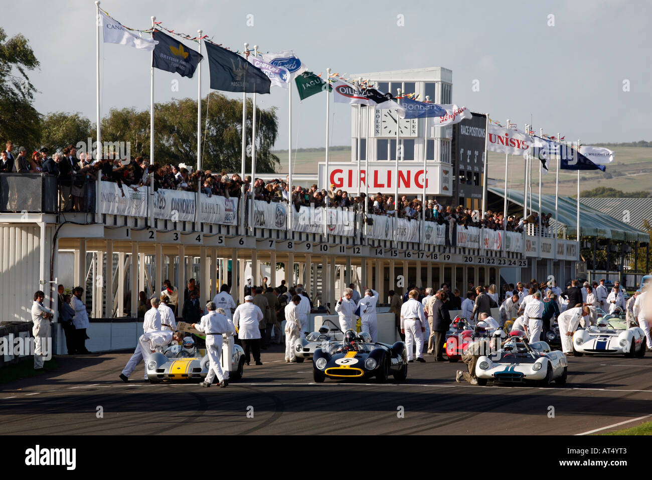 Pit area and vintage racing cars on the starting grid at the Goodwood ...