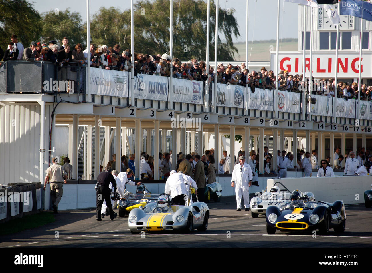 Pit area and vintage racing cars on the starting grid at the Goodwood ...