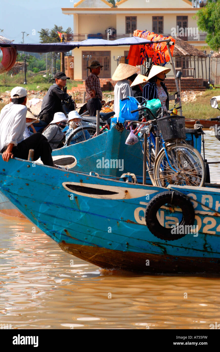Asia Far East Vietnam , Ferry boat docks by Hoi An market with men and ...