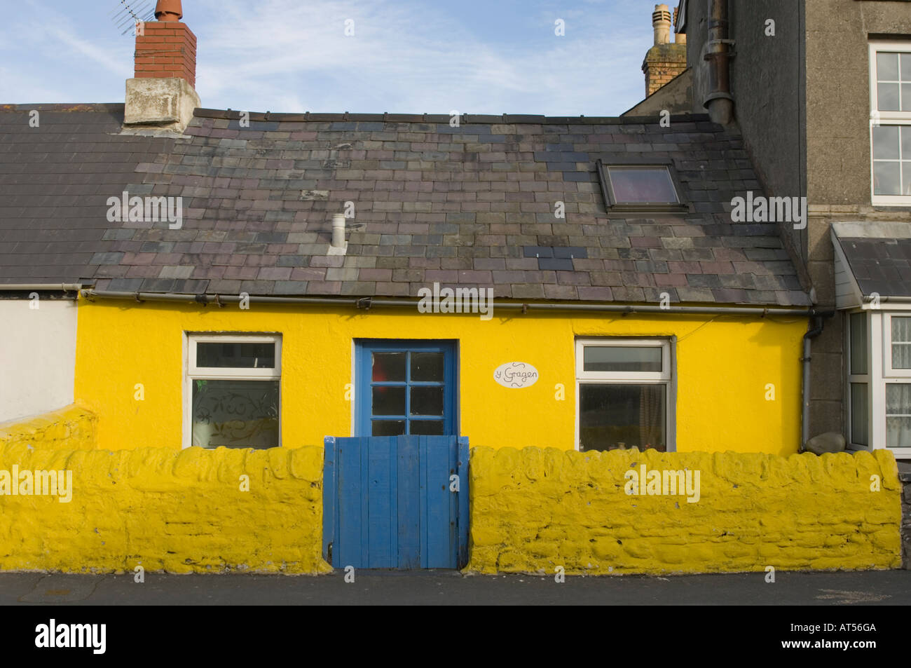 Traditional quaint pretty old welsh fisherman's cottage painted bright ...