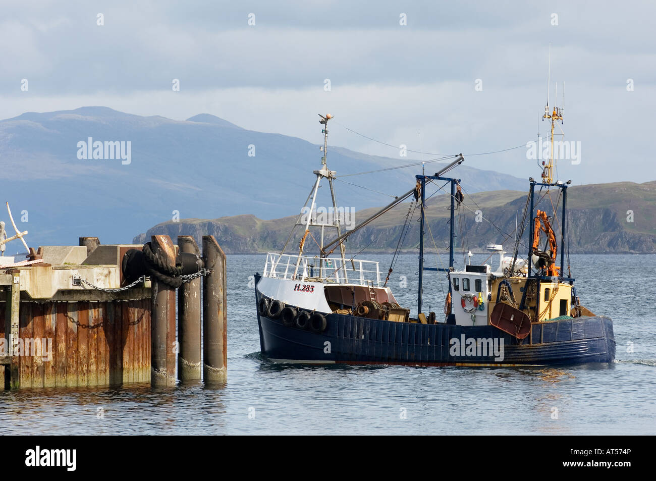 Fishing boat inshore trawler leaving Mallaig fishing port harbour on ...