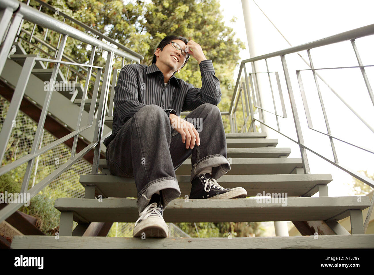 Man Sitting on Stairs, Wide Stock Photo - Alamy