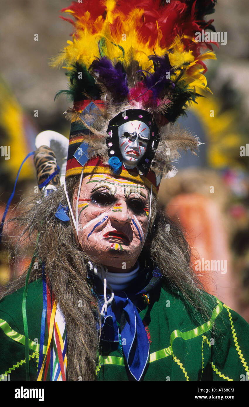 Portrait of a tobas dancer wearing a feather headdress in the Bolivian ...