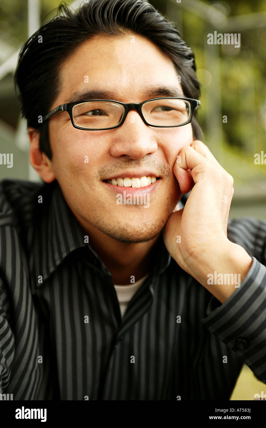 Man with Hand up to Face Stock Photo - Alamy