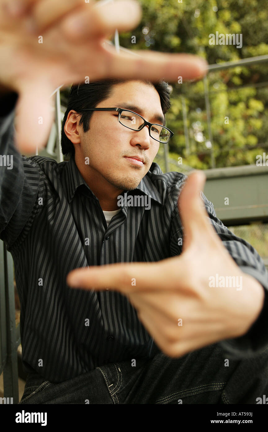 Man Framing Face with Fingers Stock Photo - Alamy