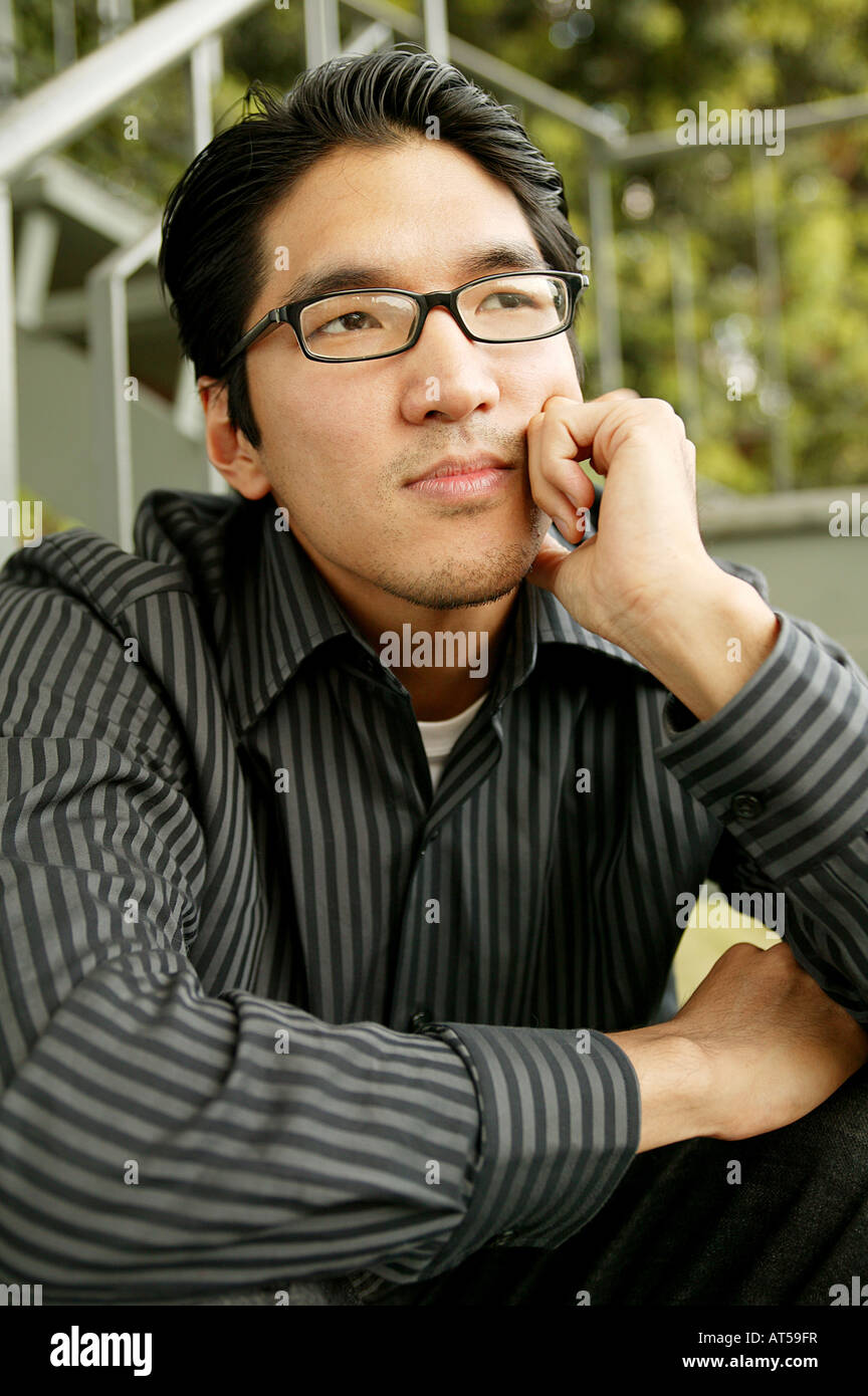 Man with Hand up to Face Stock Photo - Alamy