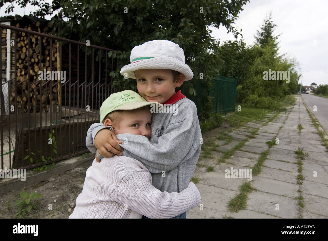 Young children hugging each other outdoors, brothers on the path Stock ...