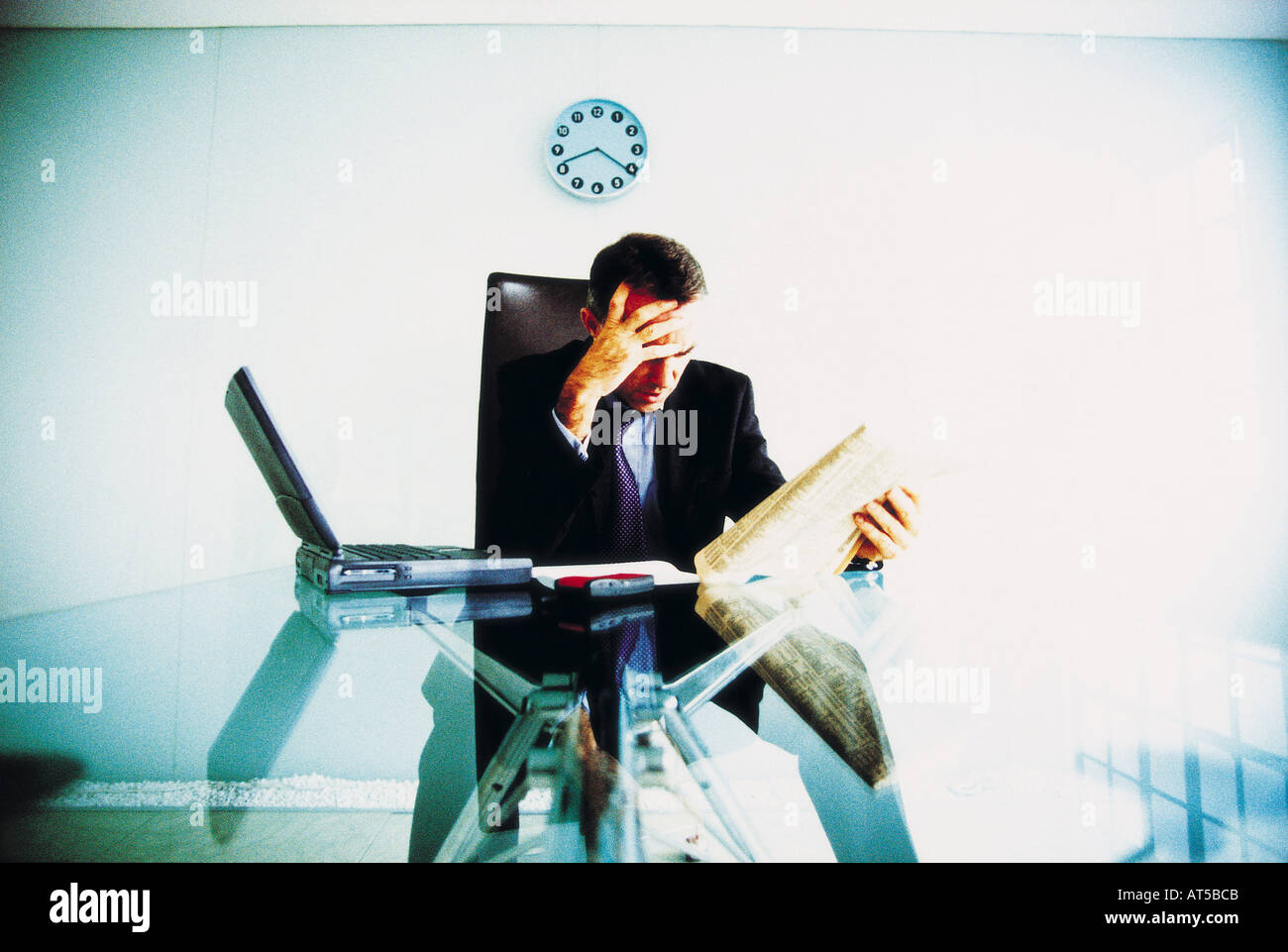 man sitting at office desk with laptop and document Stock Photo - Alamy