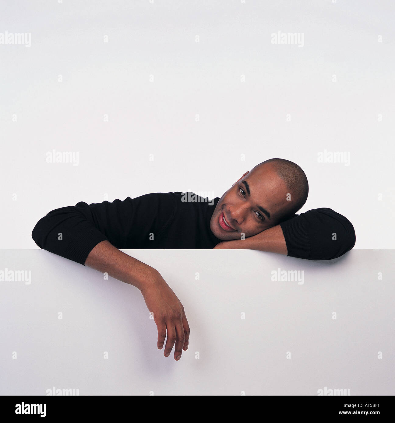 man resting on top of wall Stock Photo - Alamy