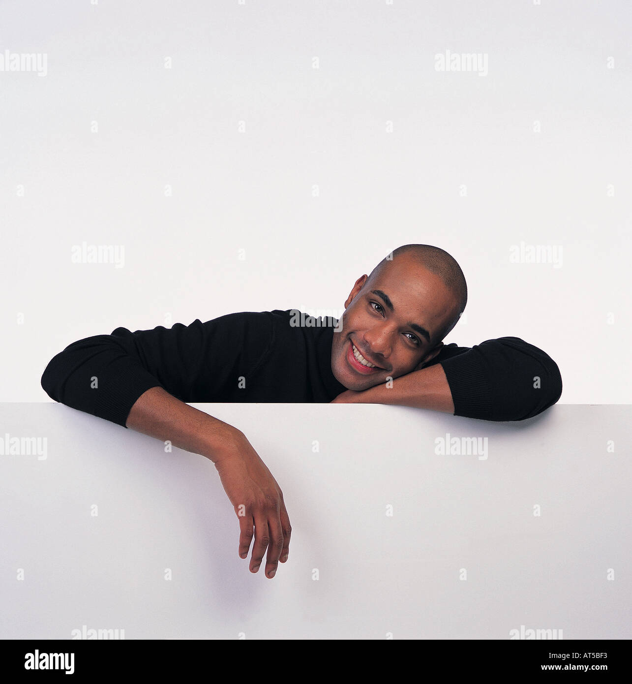 man resting on top of wall Stock Photo - Alamy