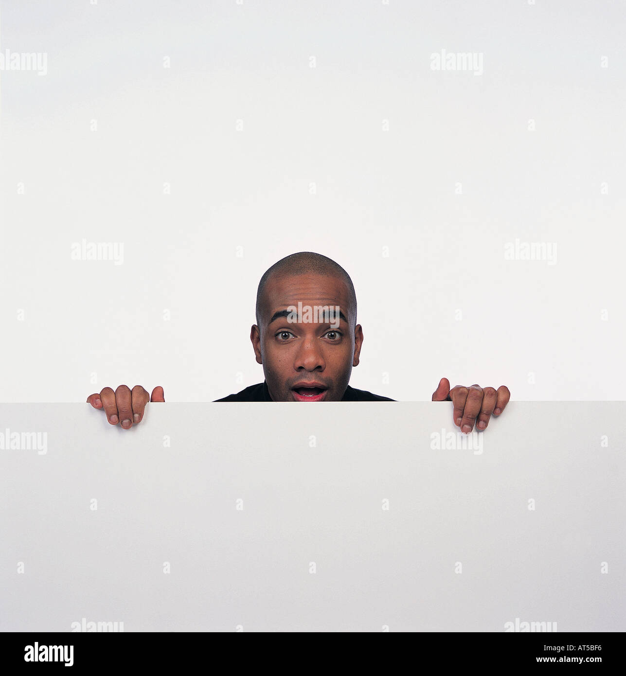 man looking over wall Stock Photo - Alamy