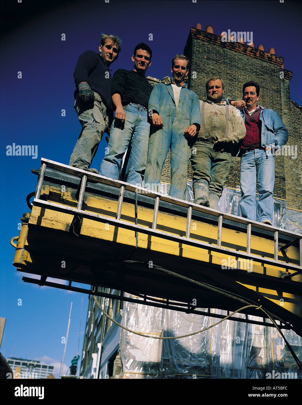 construction workers standing on steelwork structure Stock Photo - Alamy