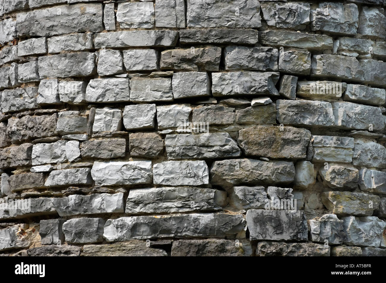 Stone wall of water overflow tower Stock Photo - Alamy