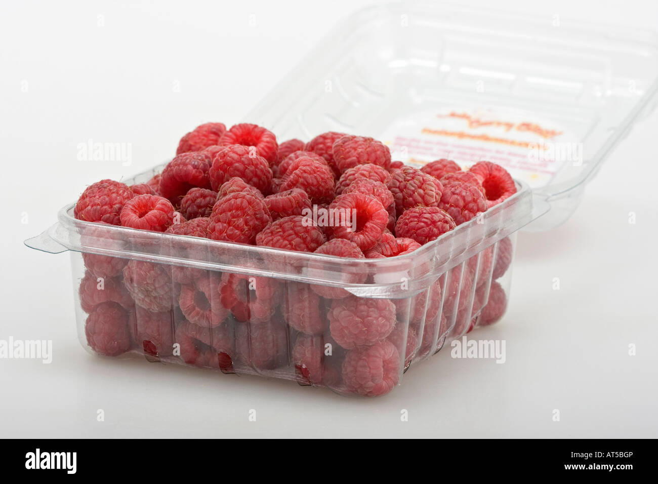 Raspberries in plastic container fruit selling at farmers market ...