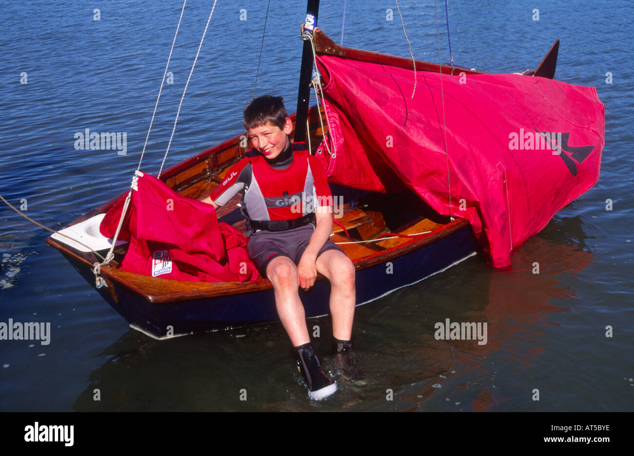 Young boy with his Mirror dinghy sailing boat Stock Photo - Alamy