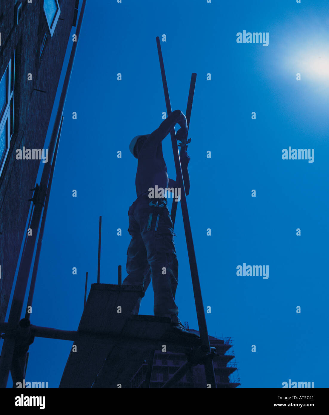 construction worker building scaffolding structure on site Stock Photo ...