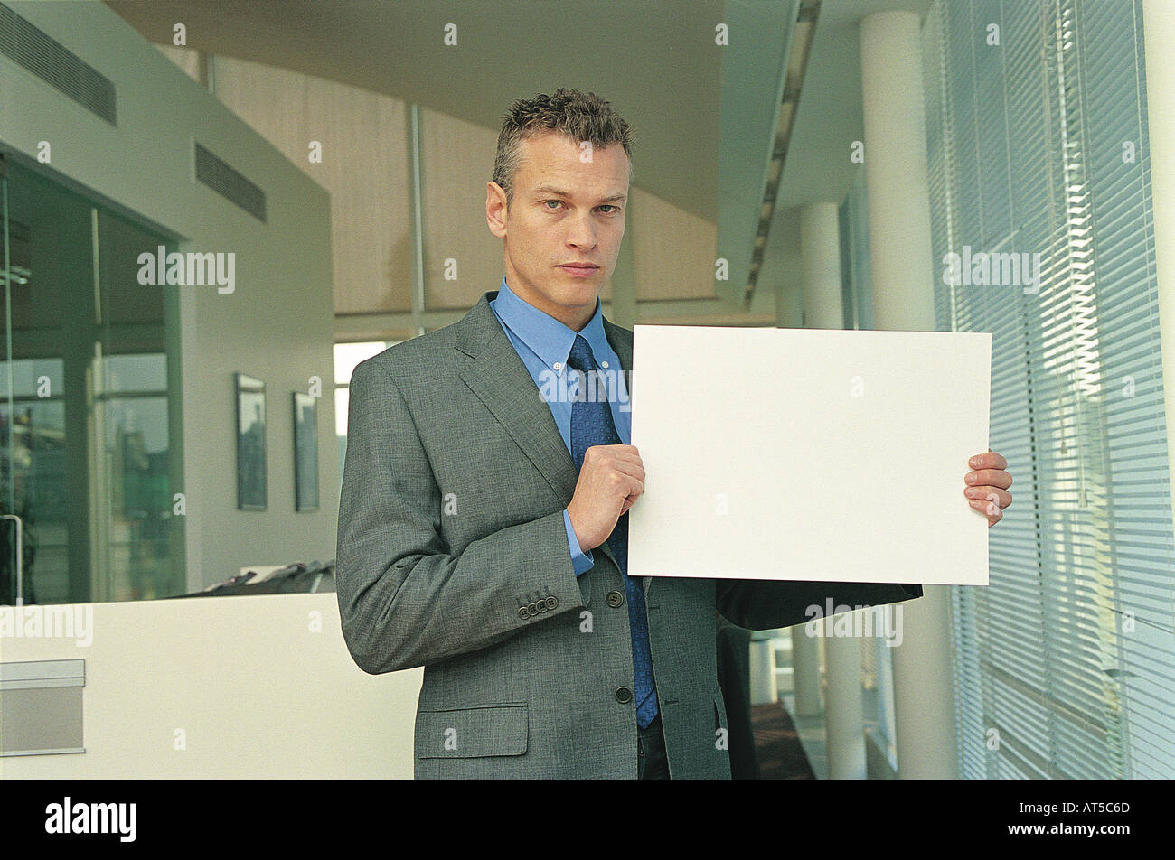 man holding sign in office Stock Photo - Alamy