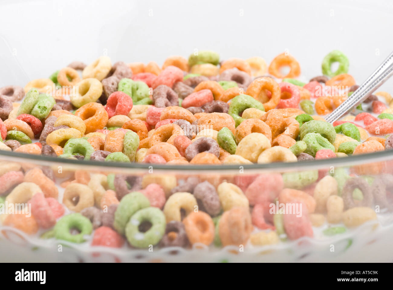 Cereal colorful rings Cheerios in glass bowl with a milk breakfast for ...