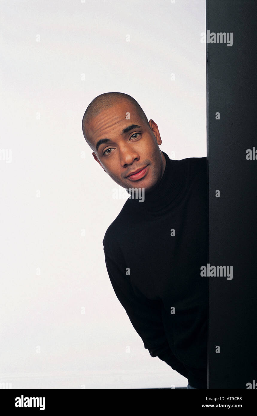 man looking round wall Stock Photo - Alamy