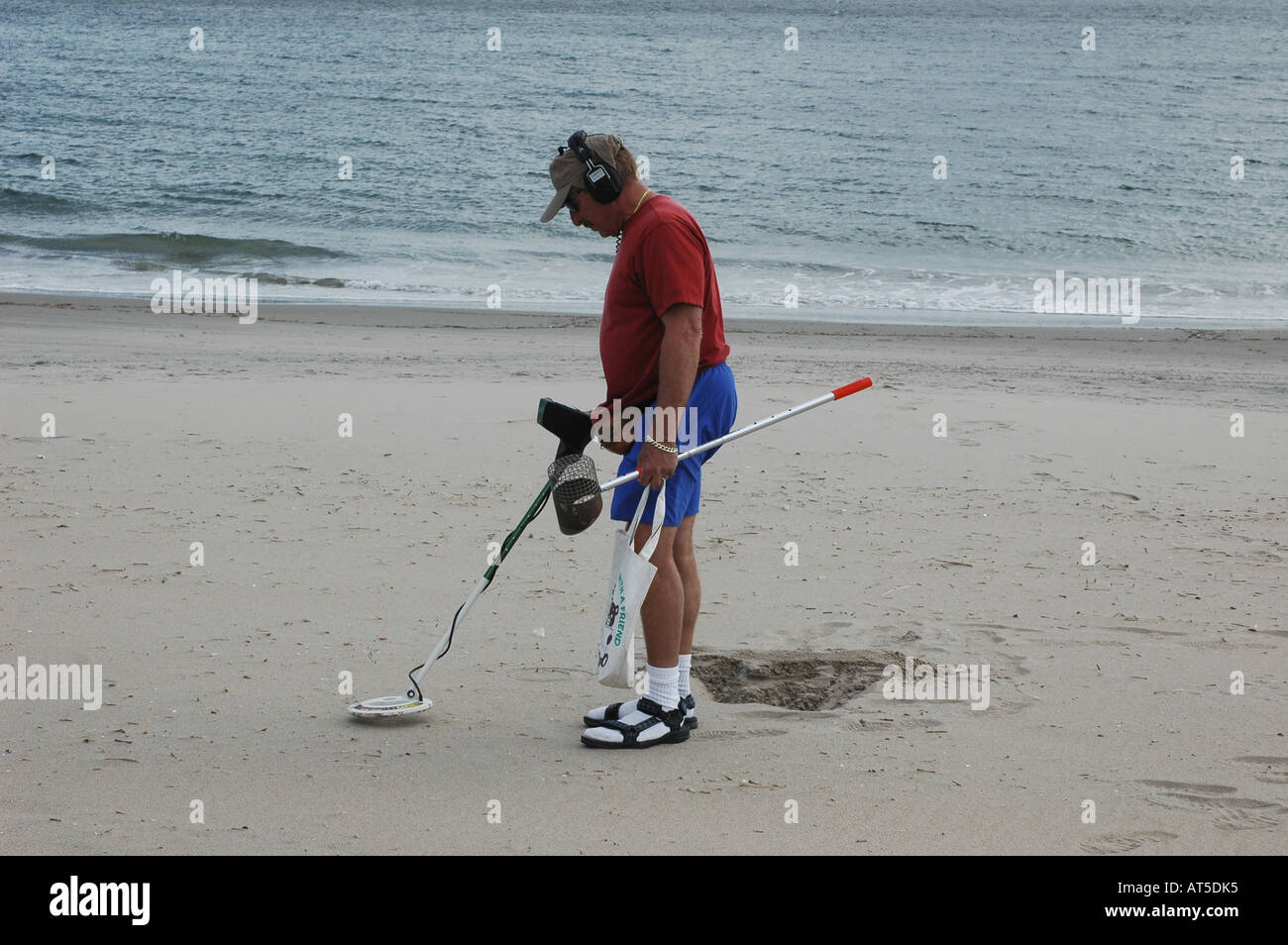 Senior man using metal detector on Coney Island Beach Brighton Beach ...