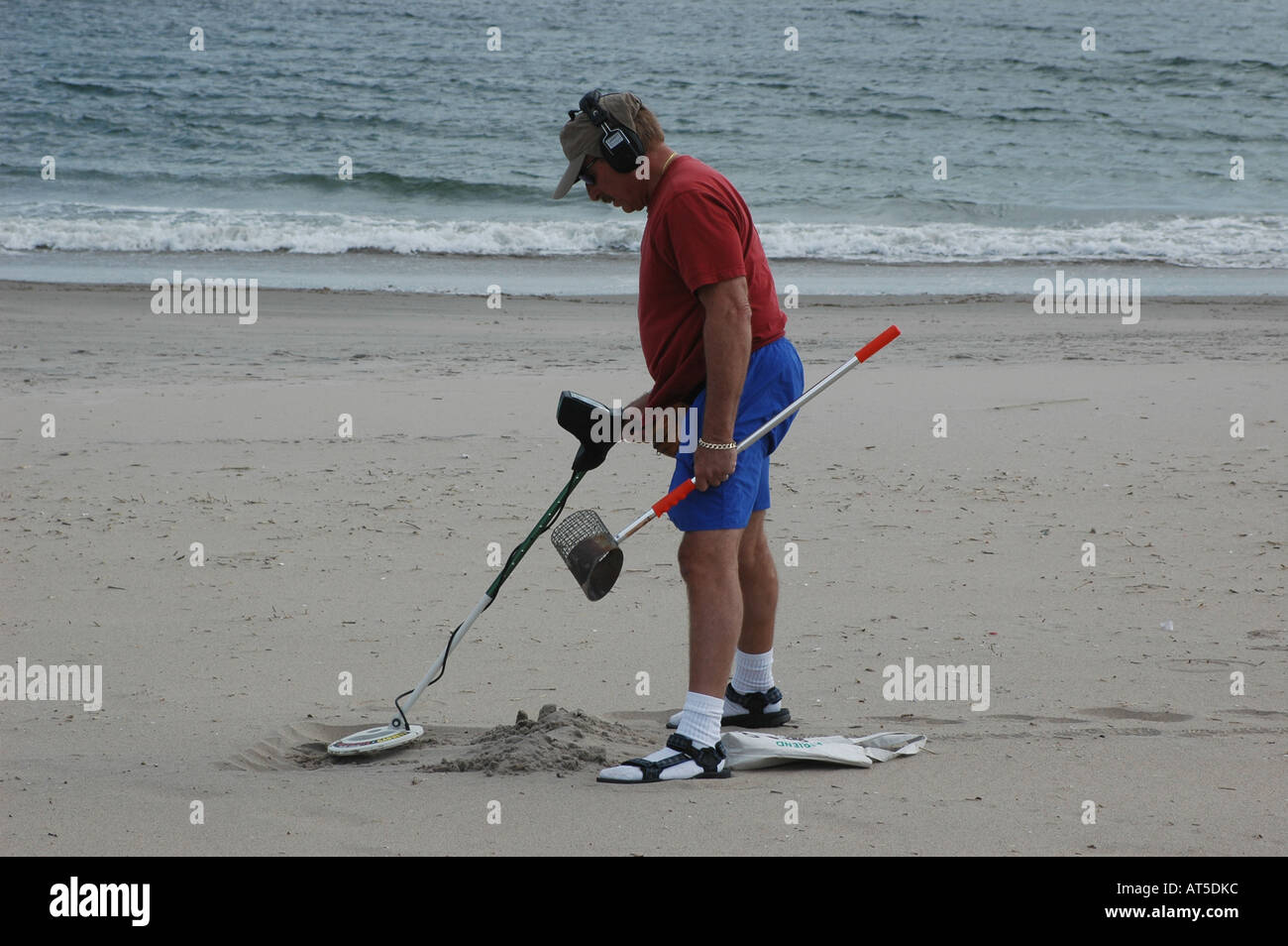 Senior man using metal detector on Coney Island Beach Brighton Beach ...