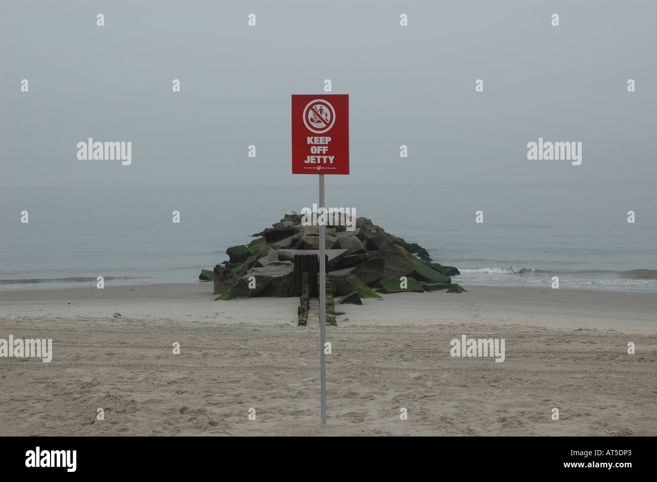 Signs for Keep Off Jetty on Coney Island beach during a bad weather on ...