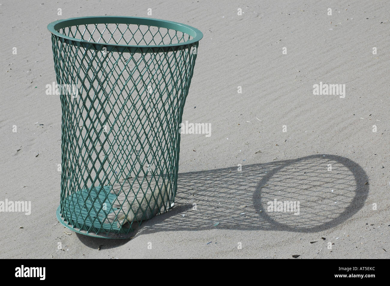 Empty dustbin with a shadow in Brighton Beach Stock Photo - Alamy