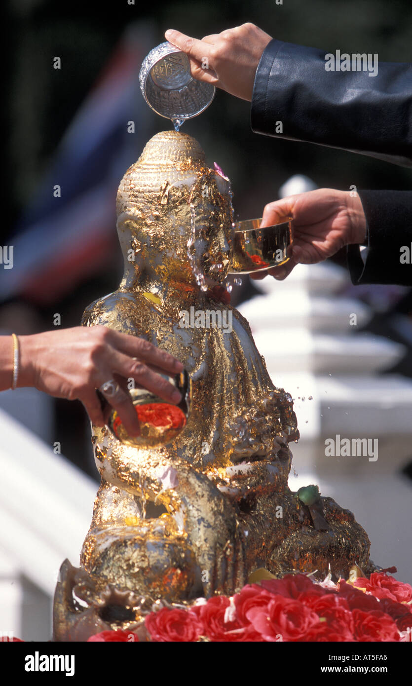 Bathing a small statue of the Buddha during Wesak celebrations Stock ...