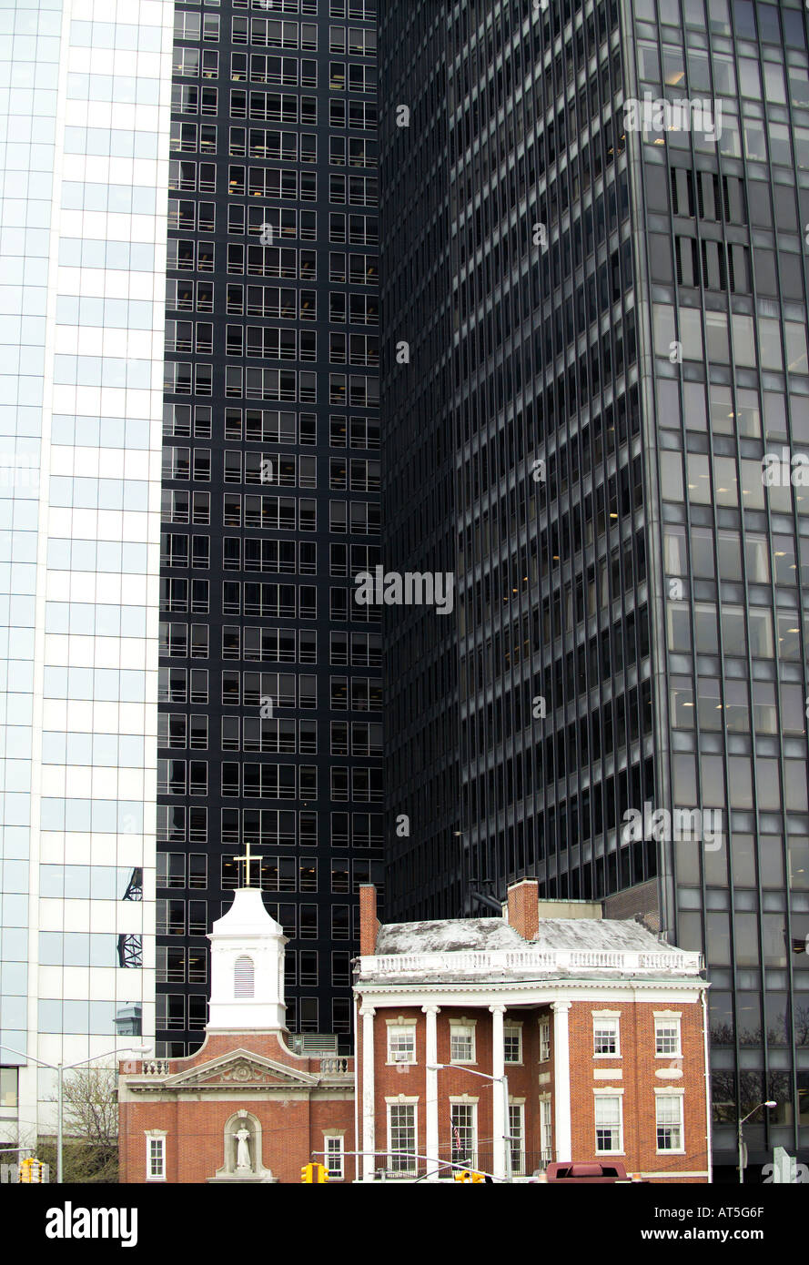 Skyscraper towering over a church in New York Stock Photo - Alamy