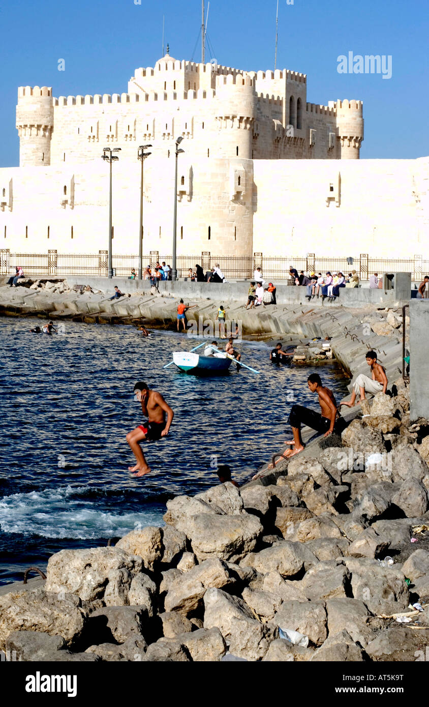 Egyptian boys swimming and diving off the rocks of the mediterranean ...