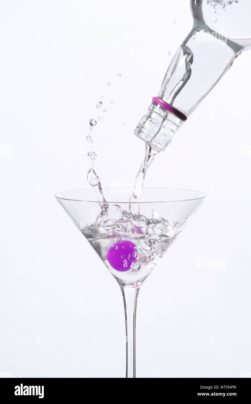 Vodka pouring into a martini glass Stock Photo - Alamy